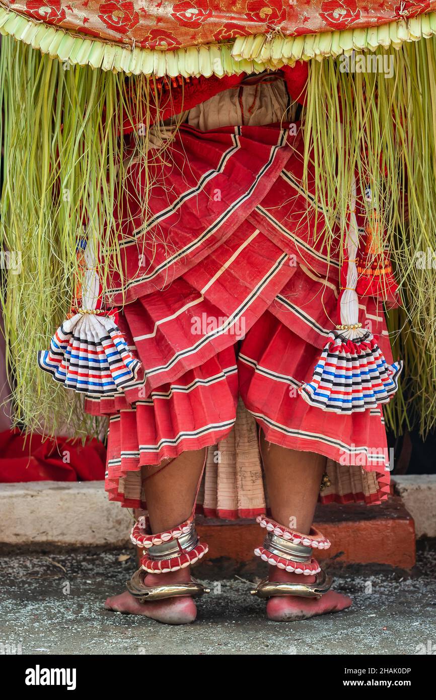 Detail of the costum of a Theyyam during hindu temple ceremony in India ...