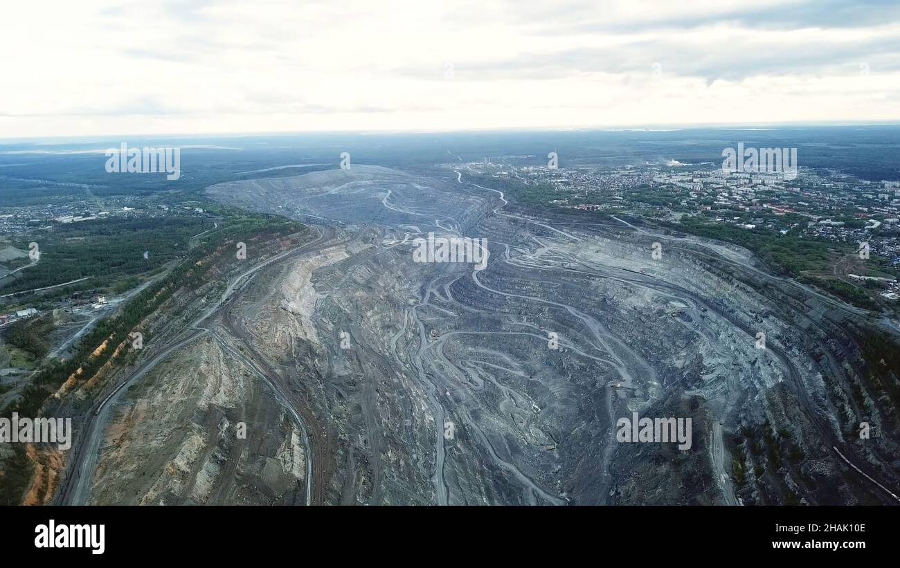 Coal mining at an open pit. Top view of the quarry. Dozers and trucks ...