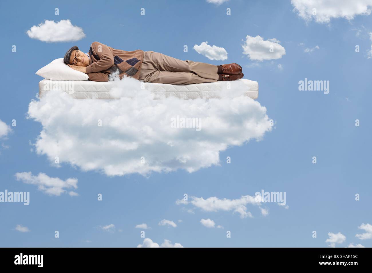 Elderly man sleeping on a mattress and floating in a blue sky with ...