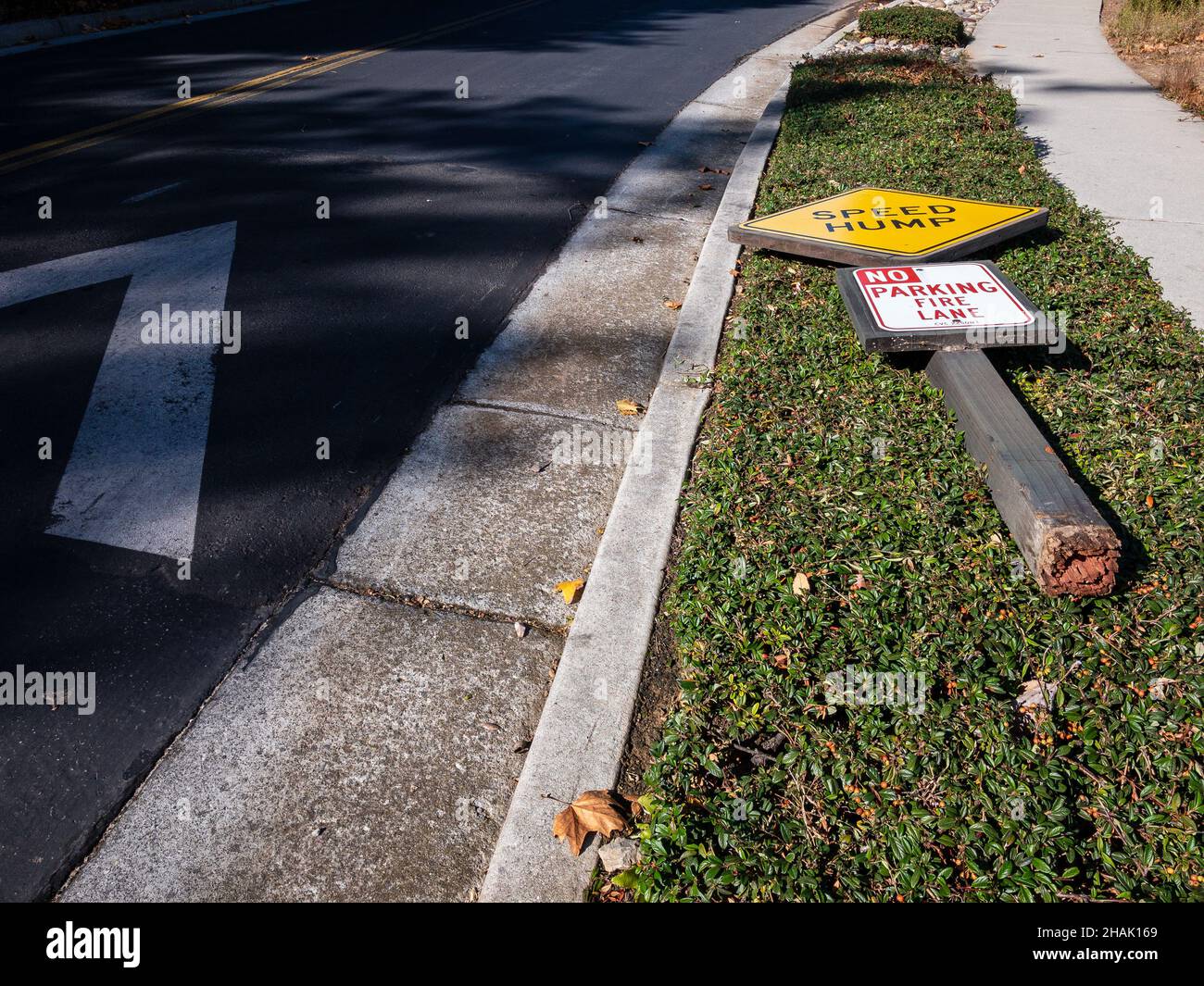 View of a fallen sign of "speed hump" and "no parking fire lane Stock ...
