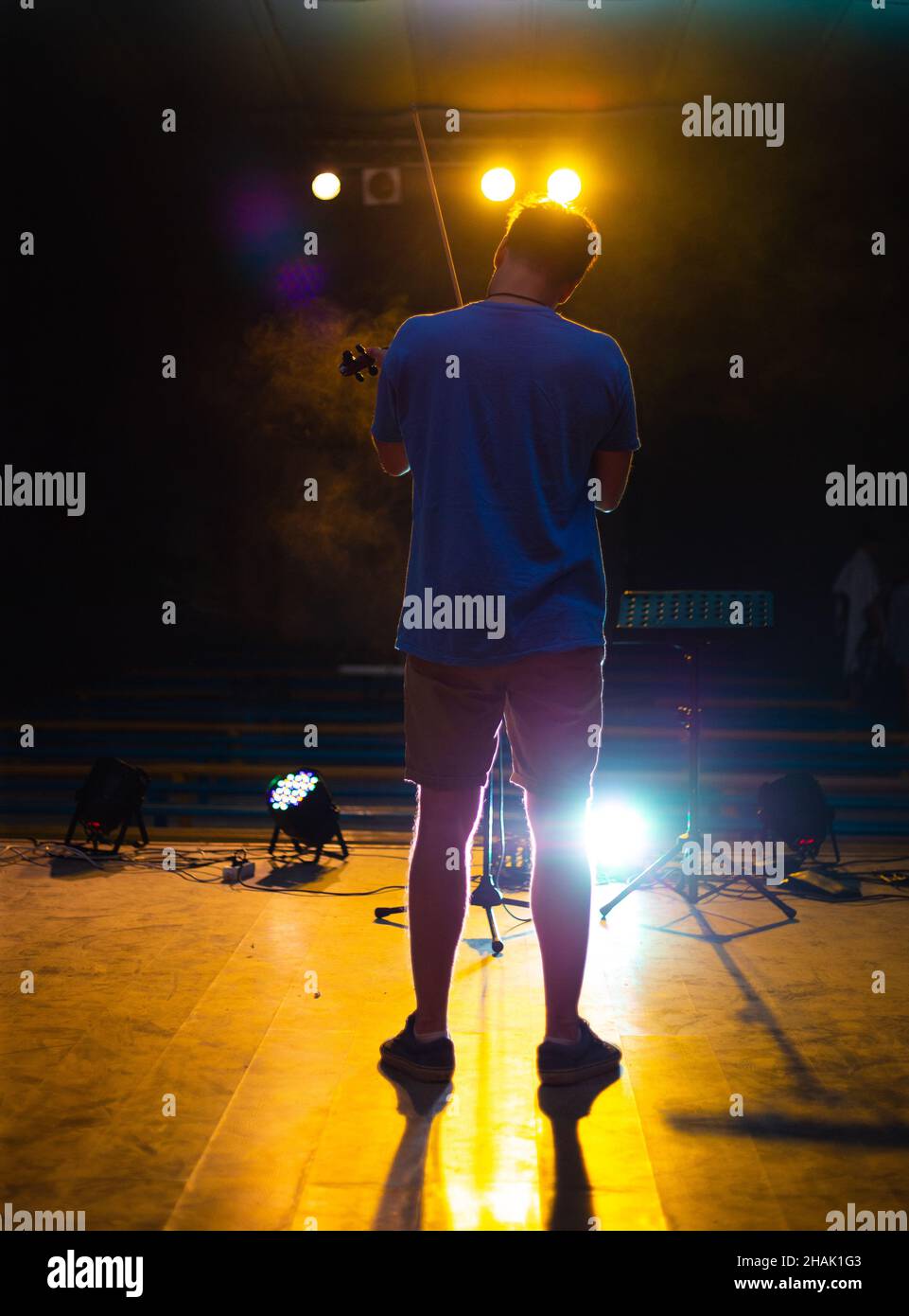 View from the back of a man playing the violin on stage Stock Photo - Alamy