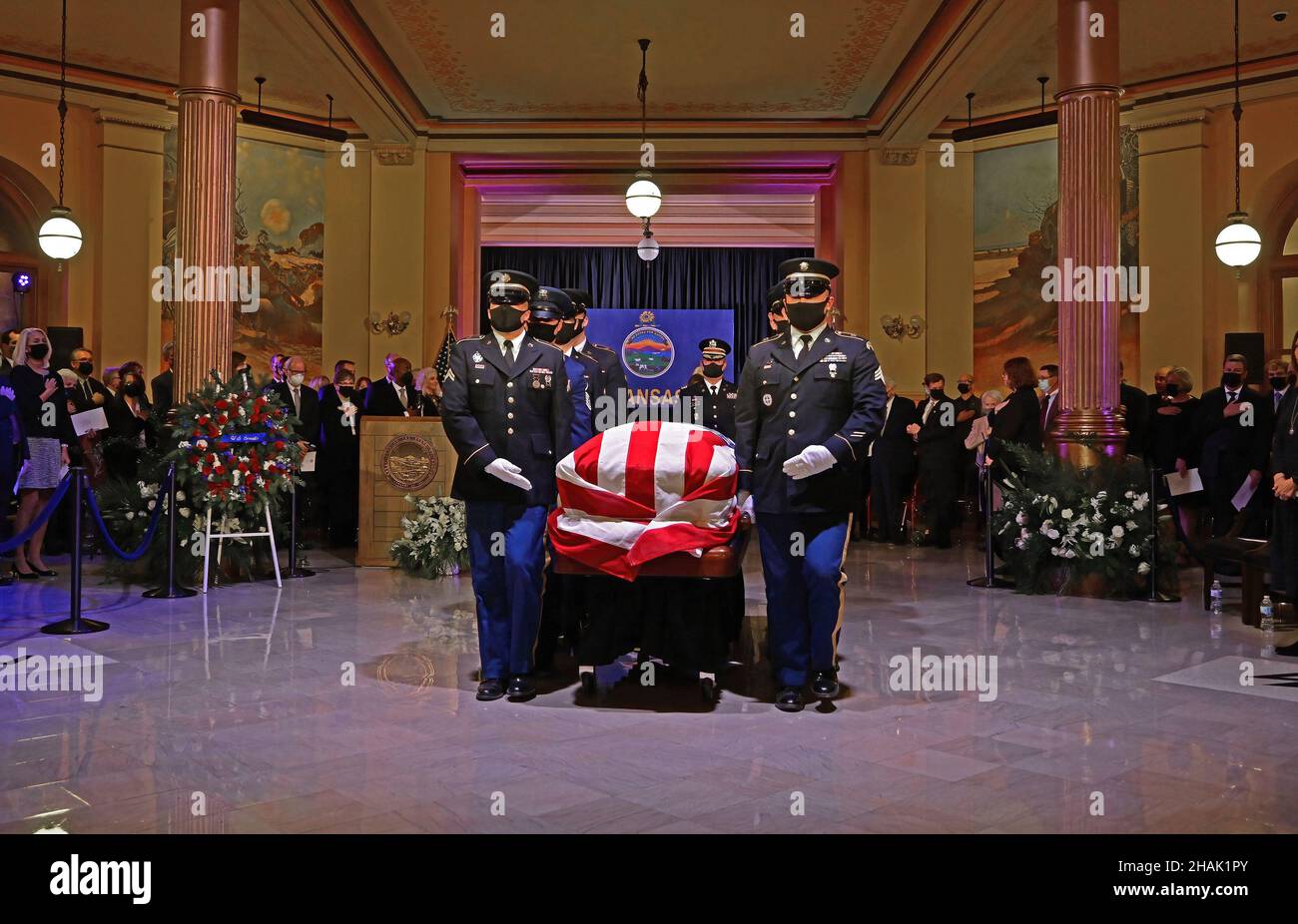Military pall bearers carry the casket of Senator Robert Dole into the ...