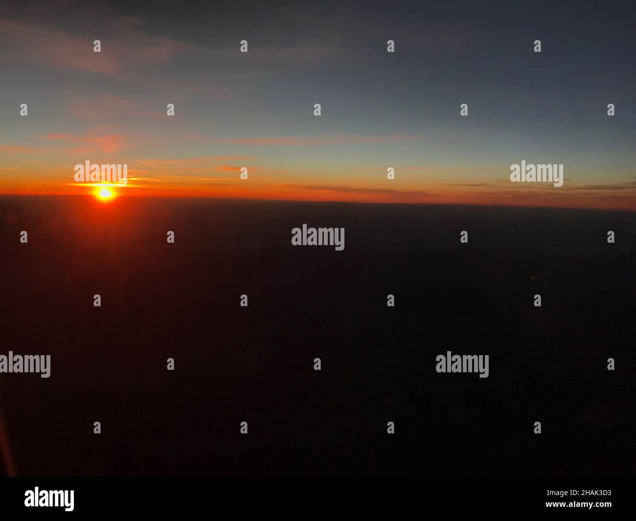 Sunset over clouds viewed from an airplane in flight Stock Photo - Alamy