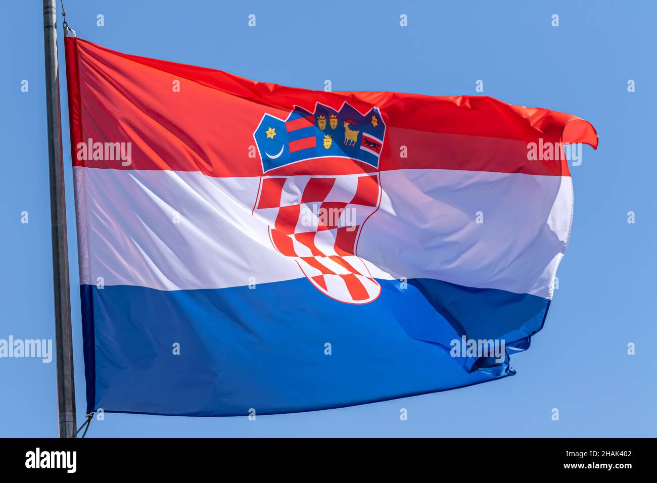 Croatian national flag waving on blue sky background. Republic of ...