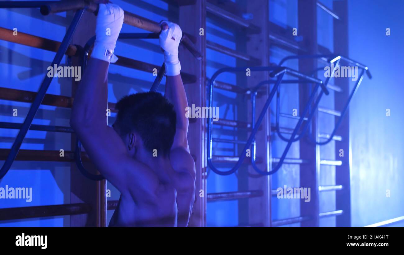 Strong man doing pull ups handsome athlete at gym. Confident muscular ...