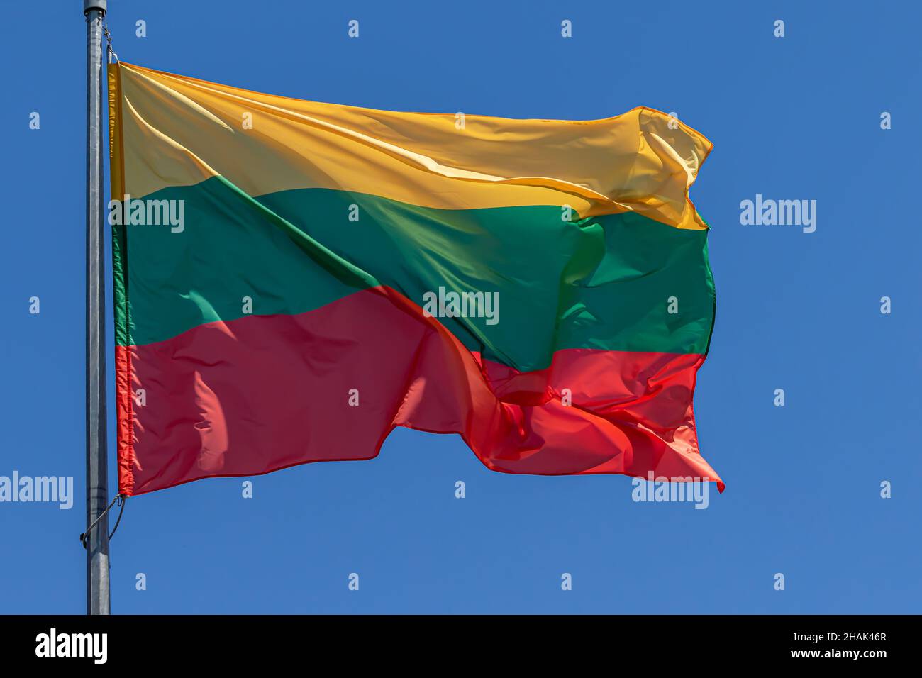 Lithuanian national flag waving on blue sky background. Republic of ...