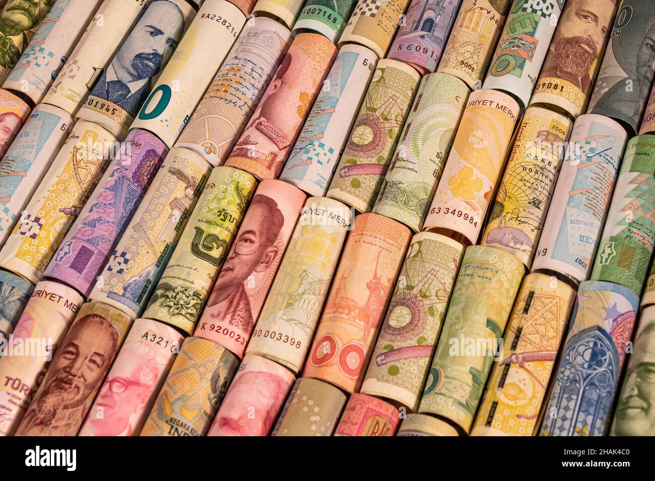 Different colourful banknotes from various countries on rolls to be ...
