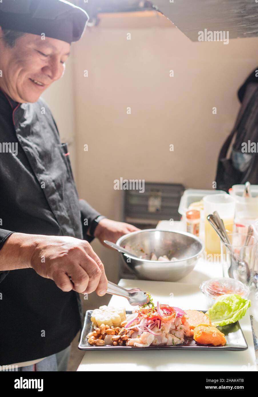 Peruvian Latinx senior chef cooking ceviche. Recipe Preparation ...