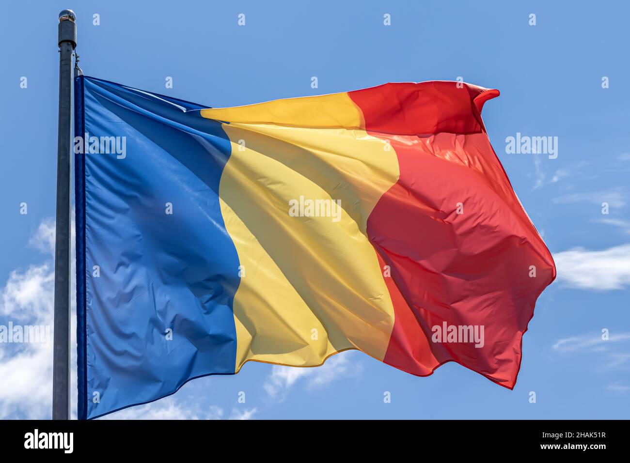 Romanian national flag waving on blue sky background. Romania, RO Stock ...