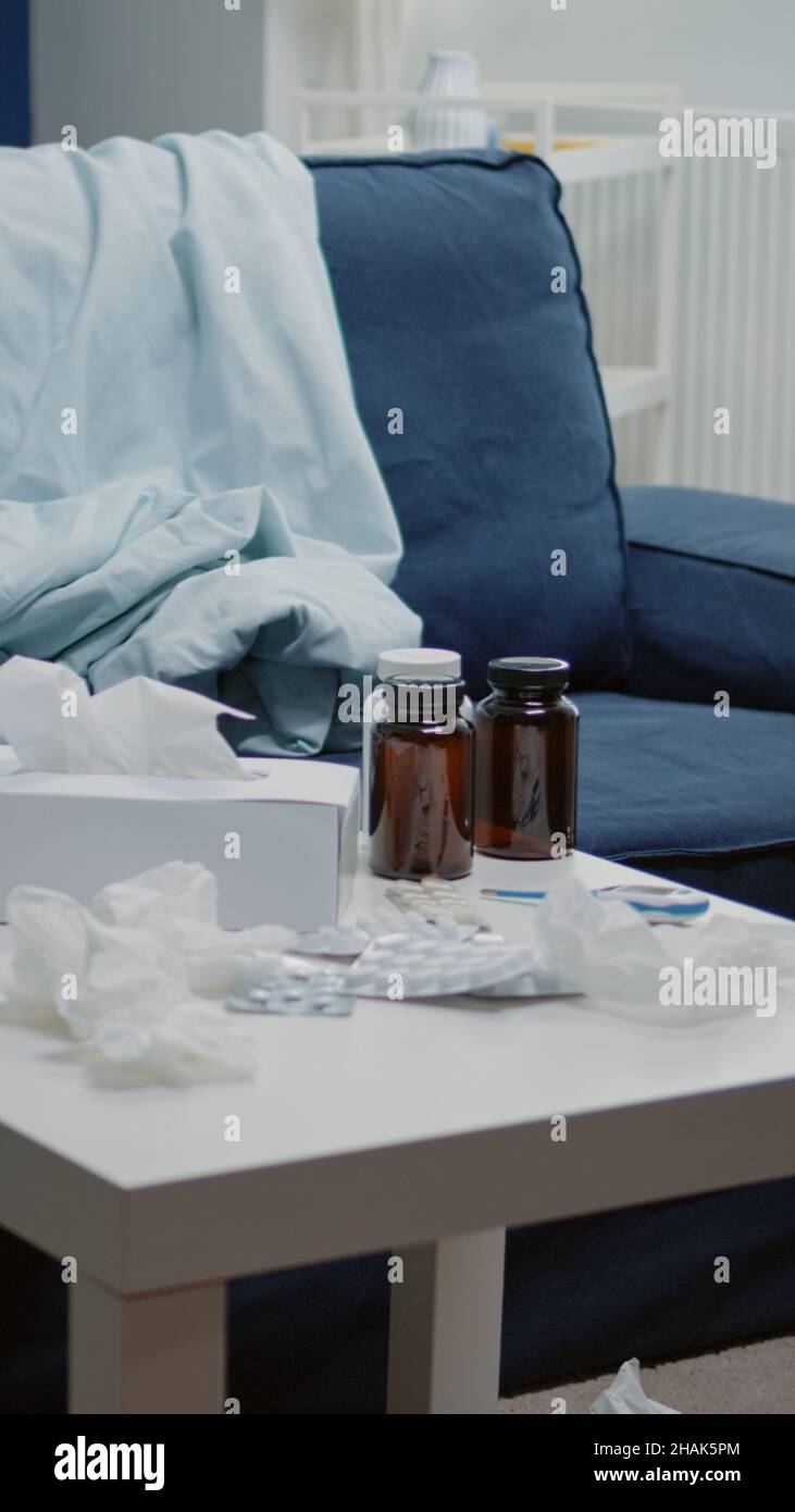 Close up of medicaments and thermometer on coffee table with nobody in ...