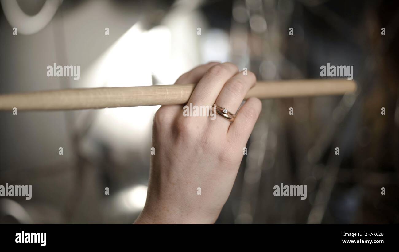 Close-up of hand with drumstick. Action. Female hand professional ...