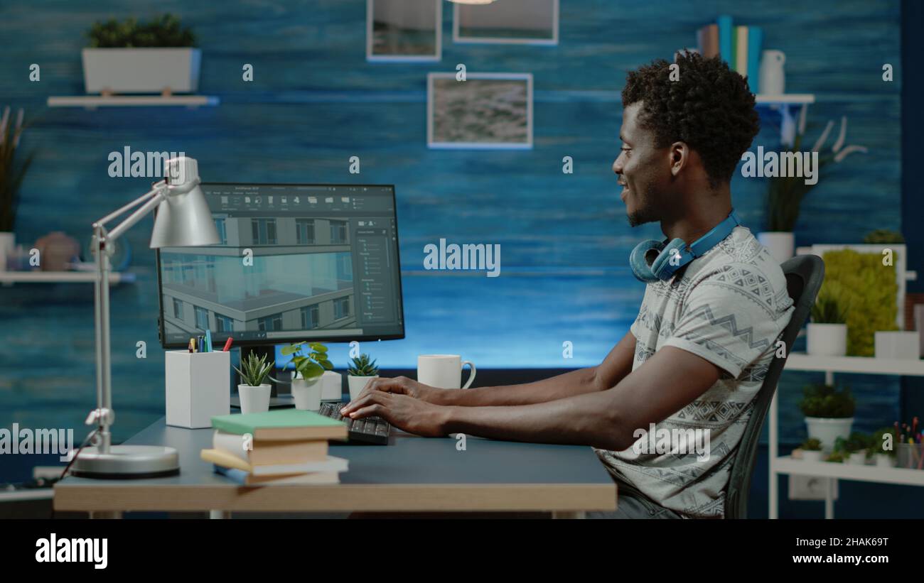 Architect working with building model on computer for construction plan ...