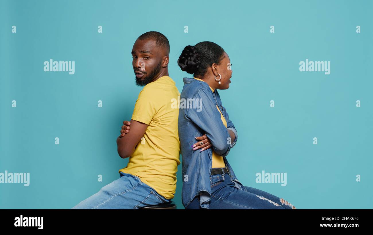 Furious couple with relationship dificulties fighting back to back in ...