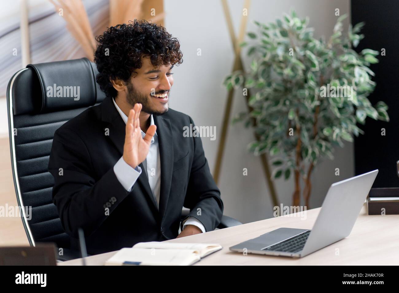 Friendly happy young adult, smart curly haired, Indian top manager, CEO ...