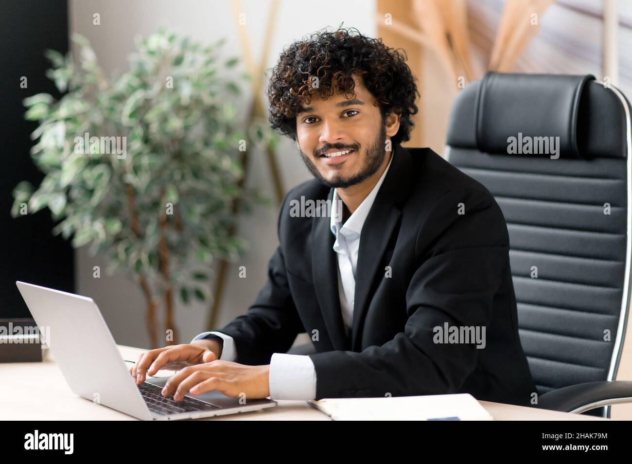 Portrait of happy successful charismatic curly haired young adult ...