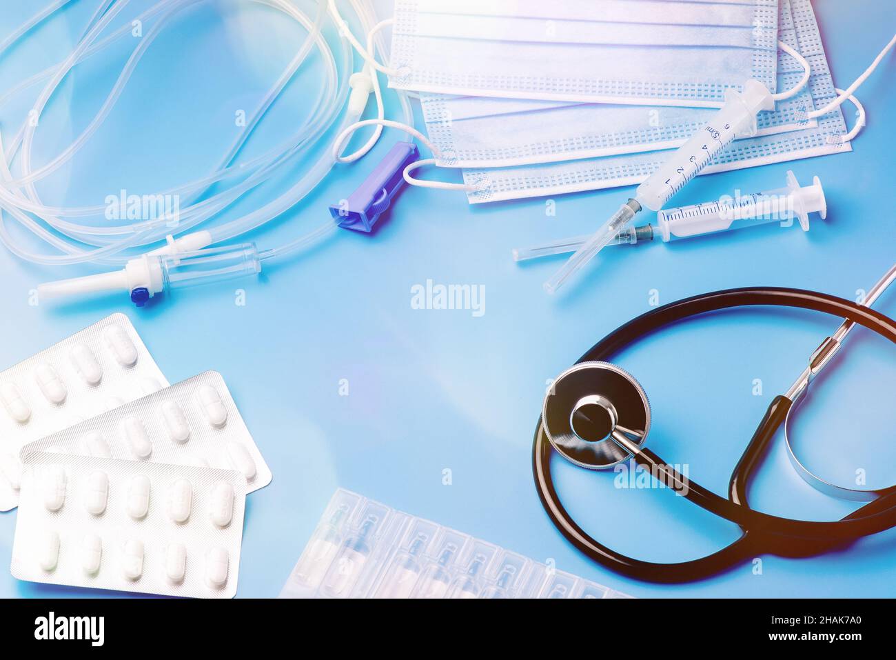 Top view doctor table with medical stethoscope, syringes, pills ...