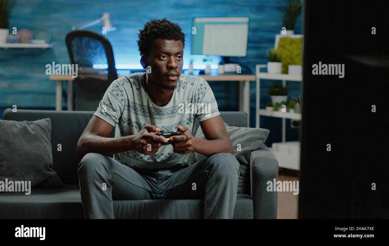 Person playing video games with joystick and TV console at home. Man ...