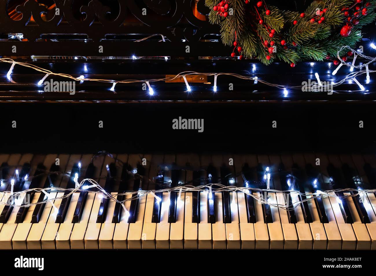Piano with glowing lights and wreath, closeup Stock Photo - Alamy