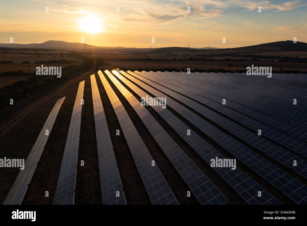 Solar panel farm under sunset sky reflecting light Stock Photo - Alamy