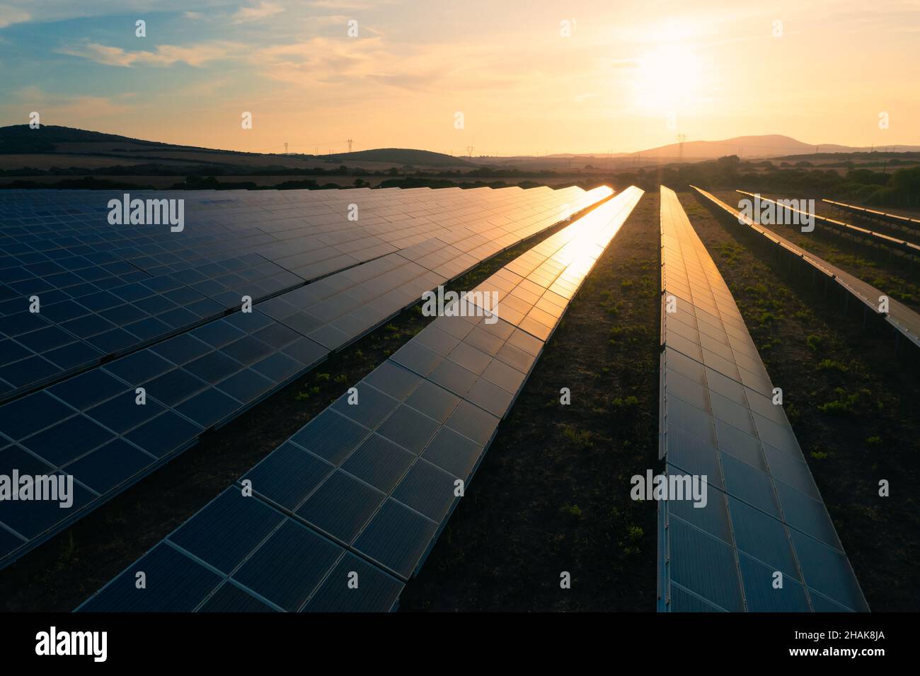 Solar panel farm under sunset sky reflecting light Stock Photo - Alamy