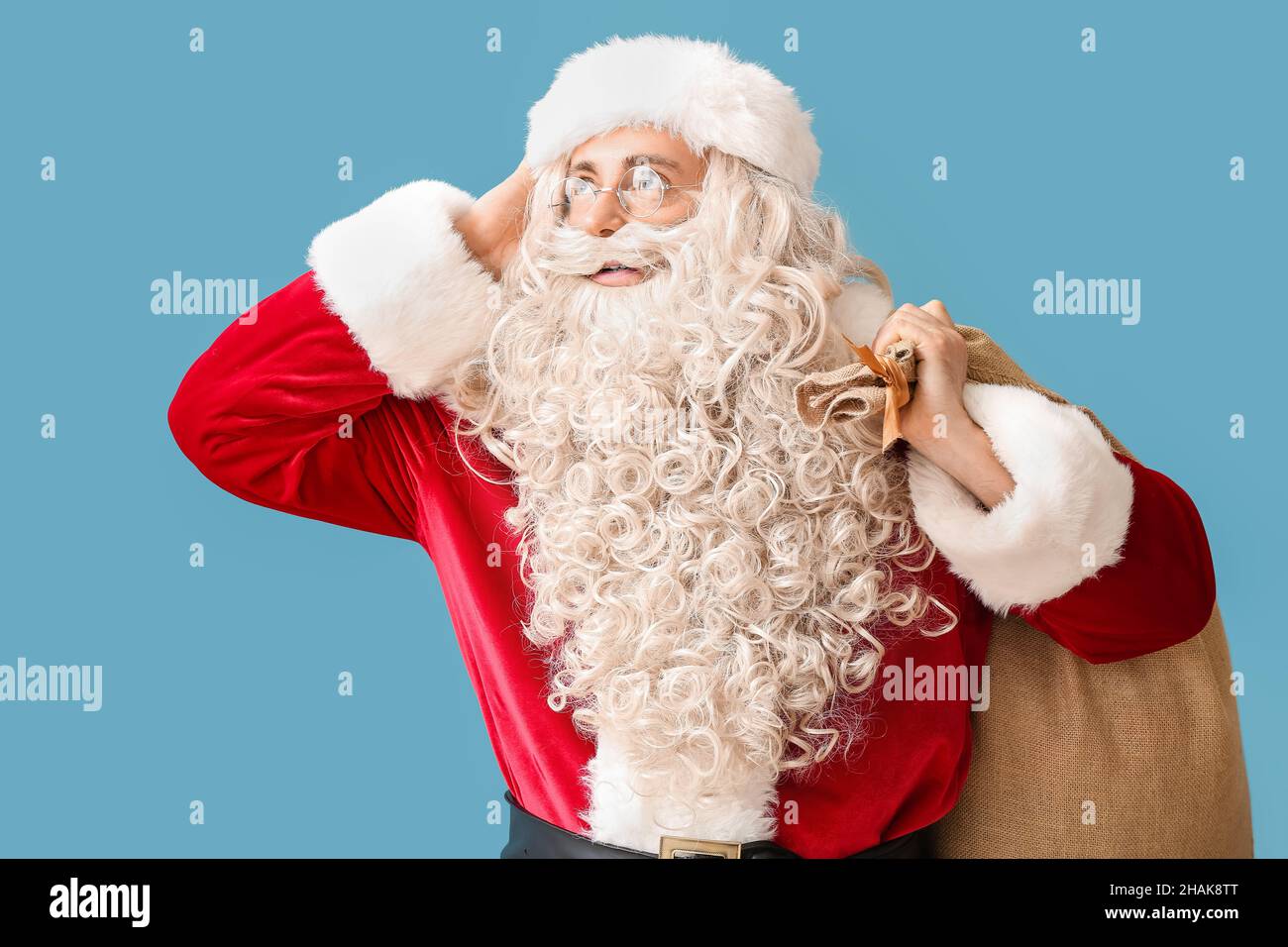 Shocked Santa Claus with sack bag on blue background Stock Photo - Alamy