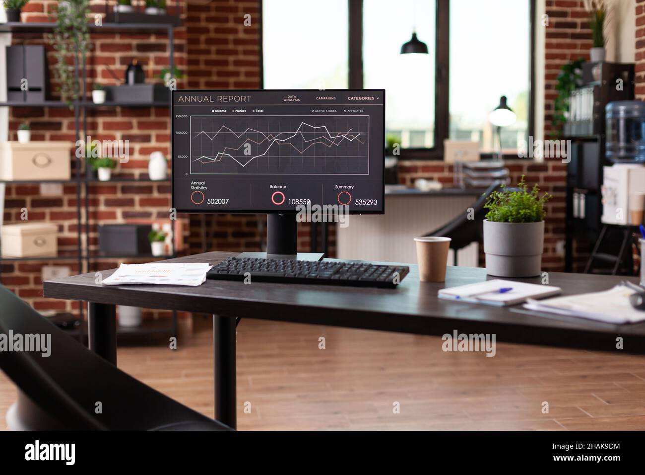 Computer with company data analysis in business office. Monitor showing ...