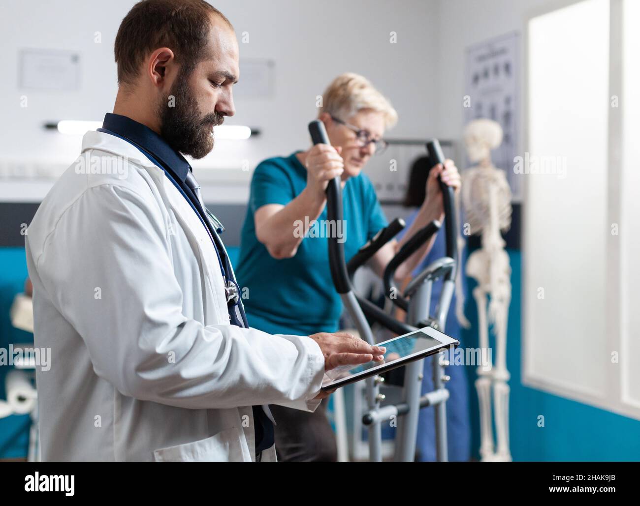 Doctor holding digital tablet for checkup with woman at recovery ...