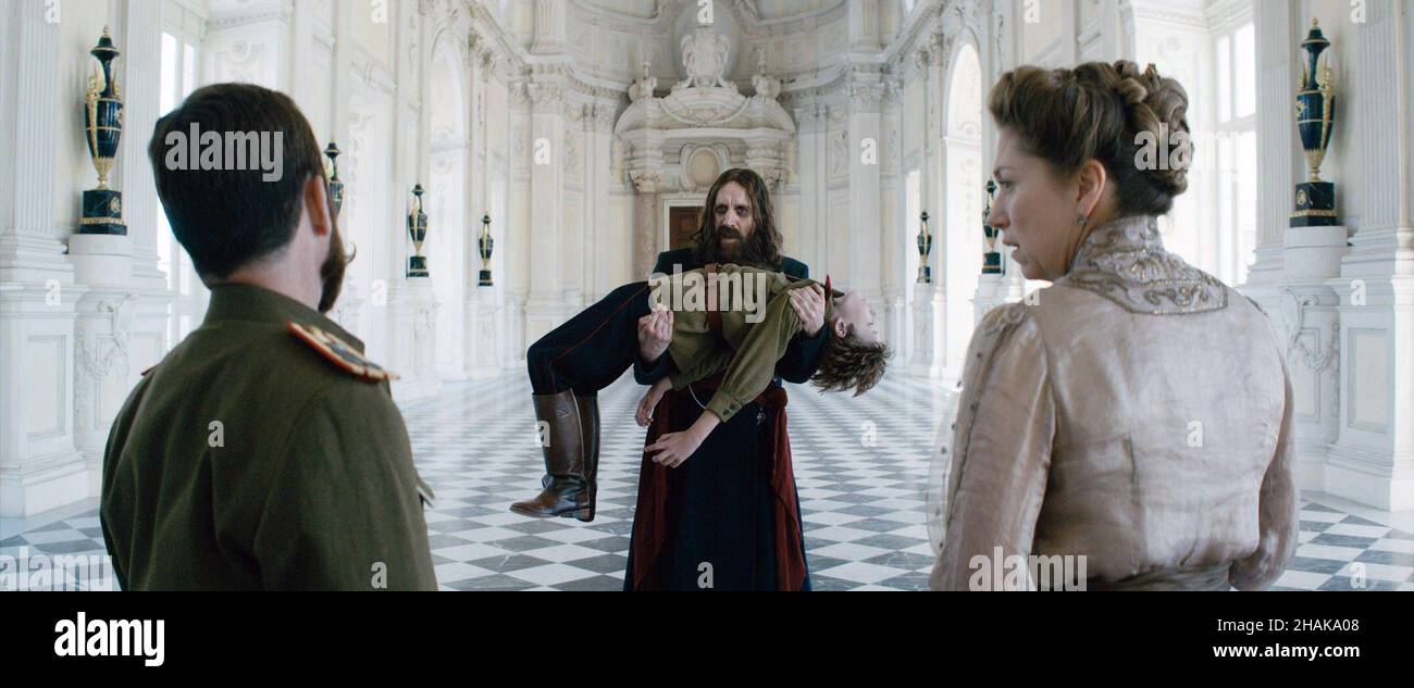 THE KING'S MAN, background: Rhys Ifans as Rasputin (carrying) Alexander ...