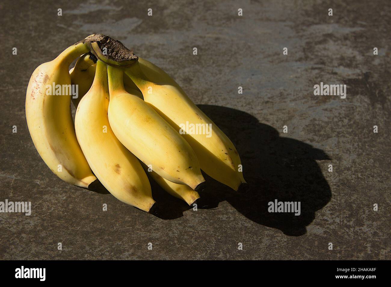 Small cluster of ripe yellow plantain on the floor in sunlight Stock ...