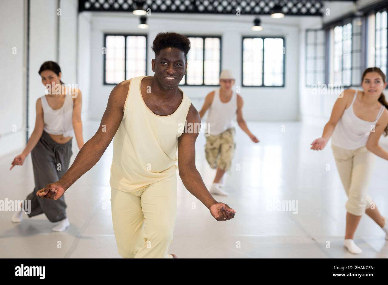 Four dancers exercising swing dance movements in large ball room Stock ...