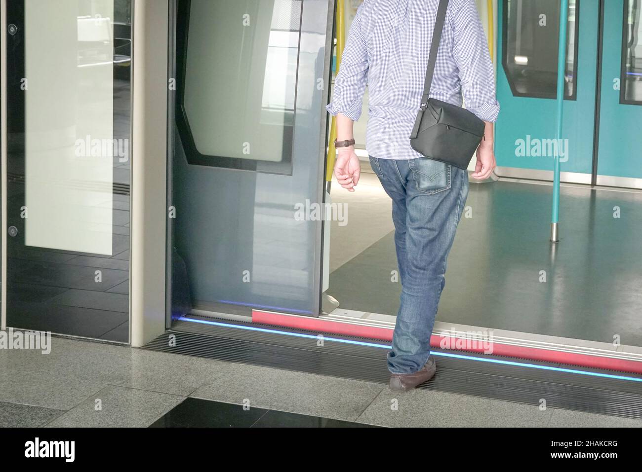Man commuter entering into a waiting subway train Stock Photo - Alamy