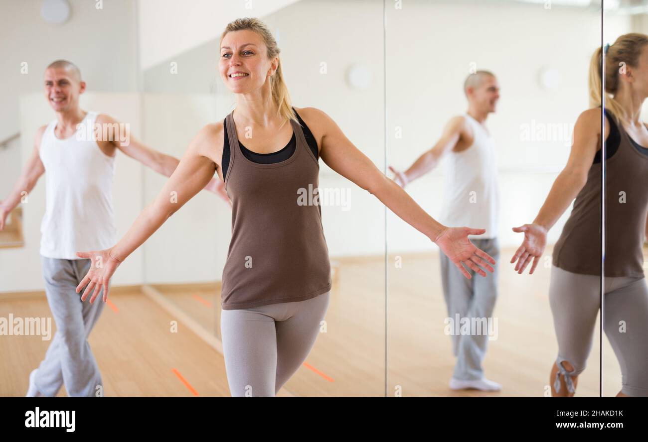 Happy adults training swing steps at dance class Stock Photo - Alamy