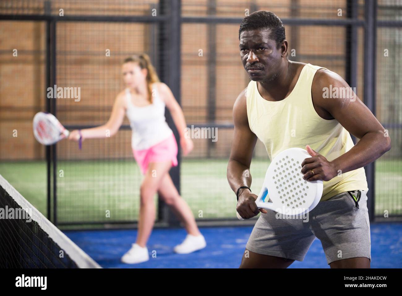 Padel tennis player posing in court Stock Photo - Alamy