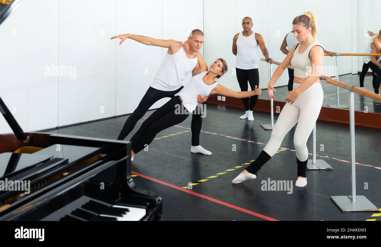 Lesson in ballet school - men and women perform ballet exercises Stock ...