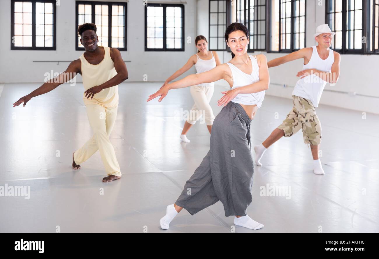 Group of dancers training modern dance moves in ball room Stock Photo ...