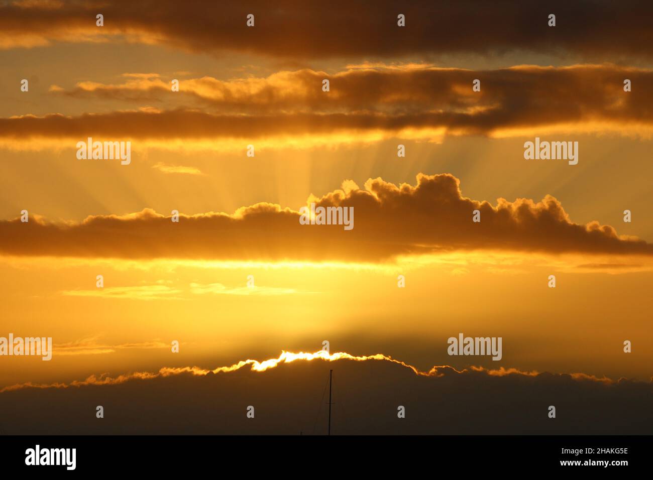 Beams of light shining through the clouds during sunrise in Key West ...