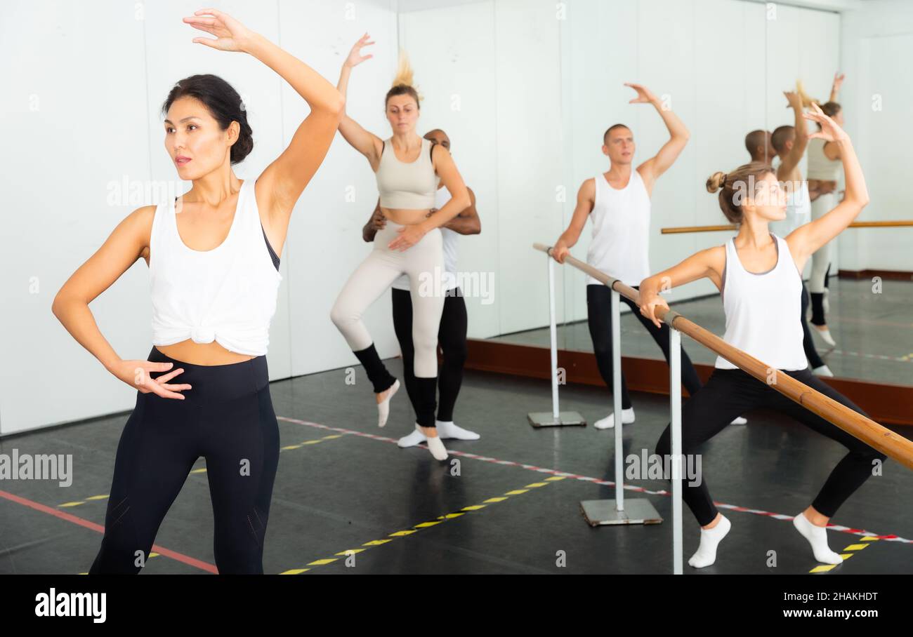 .Sporty guys and girls performing beautiful dance elements Stock Photo ...