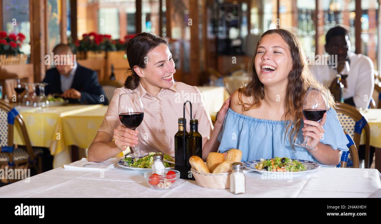 Two best friends have fun talking at a table in a restaurant Stock ...