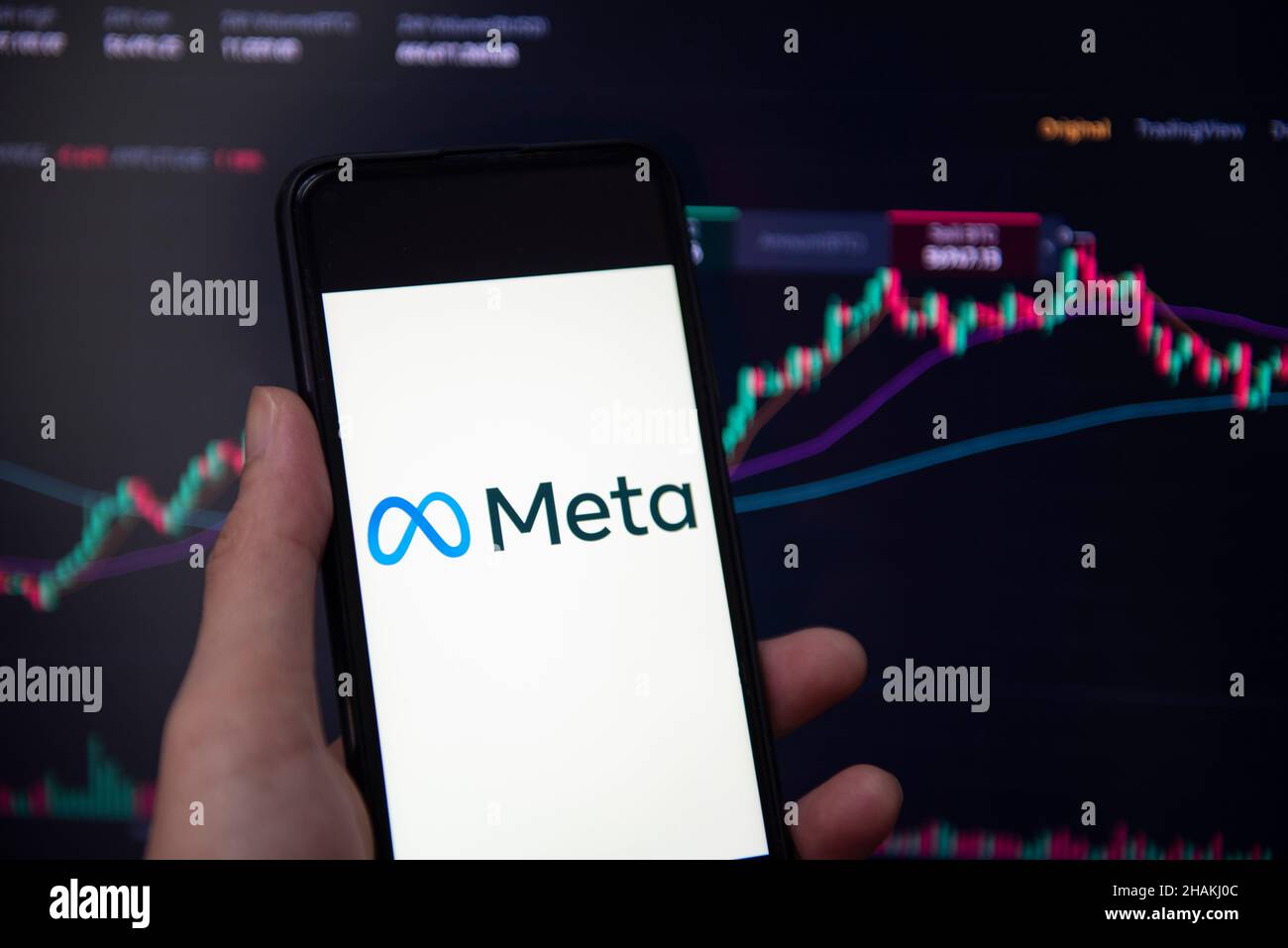 META logo on smartphone screen with hand hold and crypto currency or ...