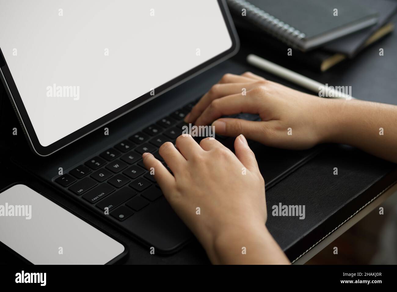 Close-up, Female or businesswoman typing on tablet's keyboard at her ...