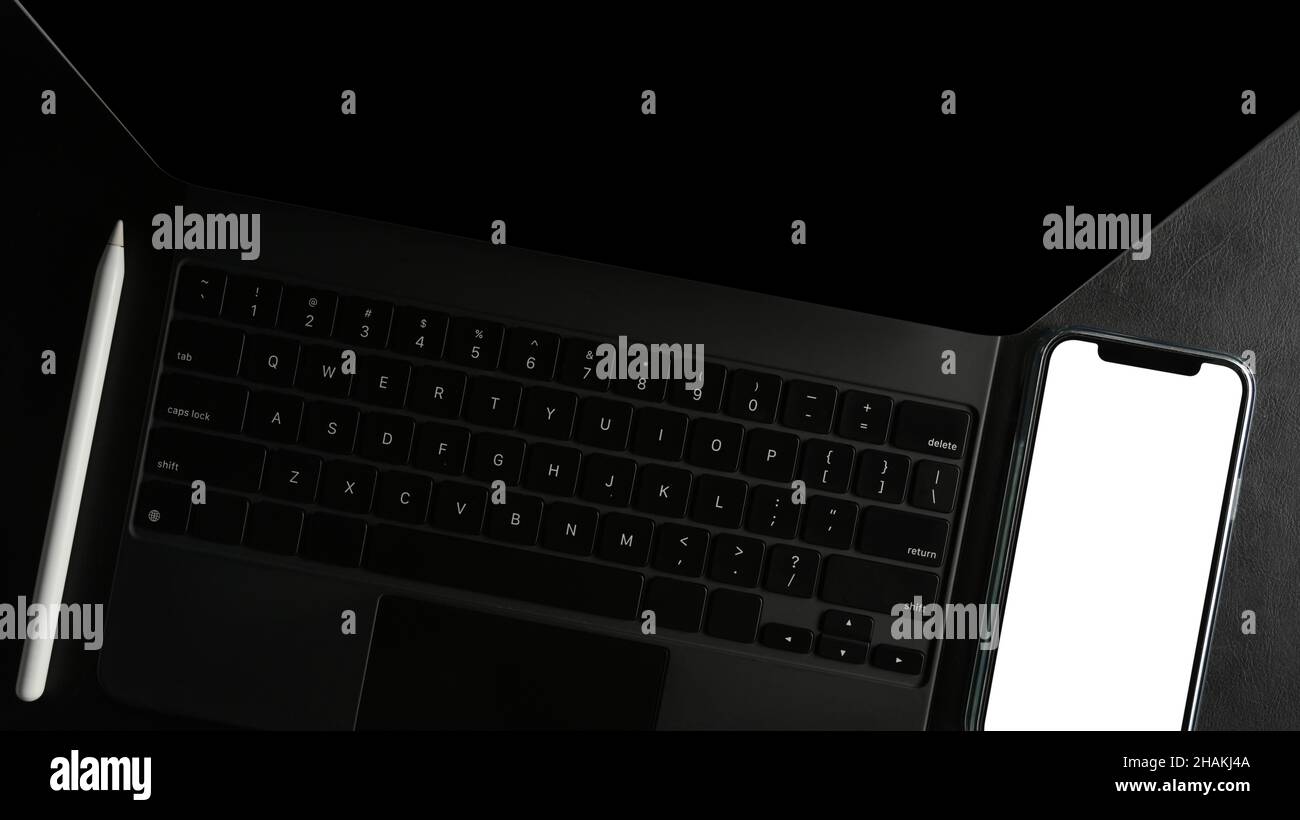 Close-up, top view of a modern black tablet or touchpad computer with ...