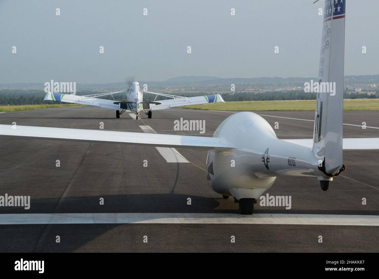 A tow plane pulls a glider into position on the flight line at U.S. Air ...