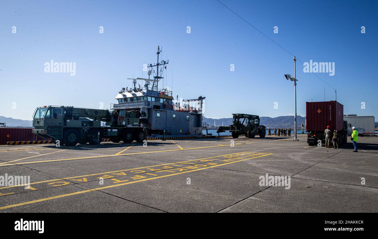 Vehicles with Marine Wing Support Squadron 171 offload containers from ...