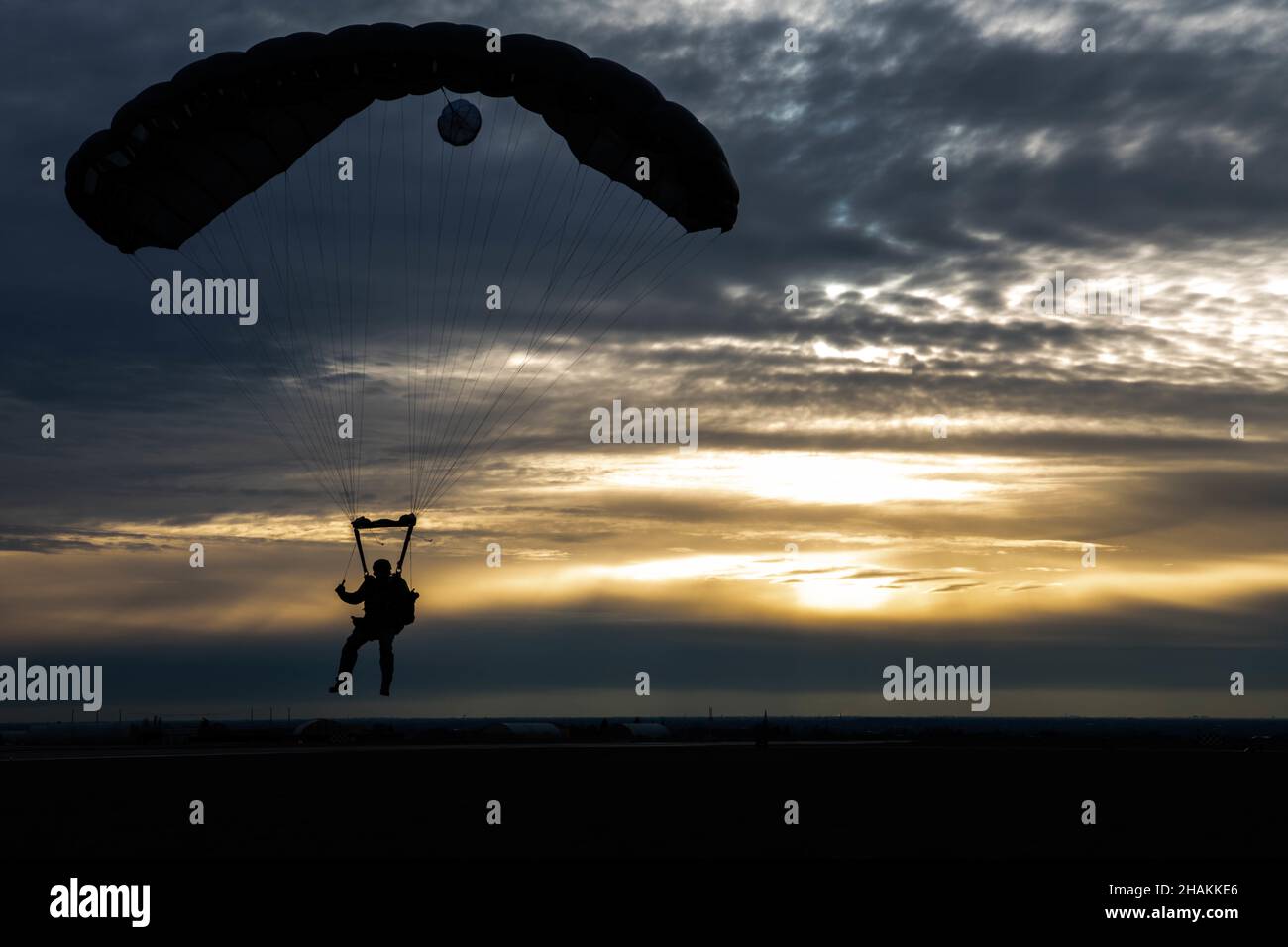 U.S. Airmen assigned to the 57th Rescue Squadron parachute to a drop ...