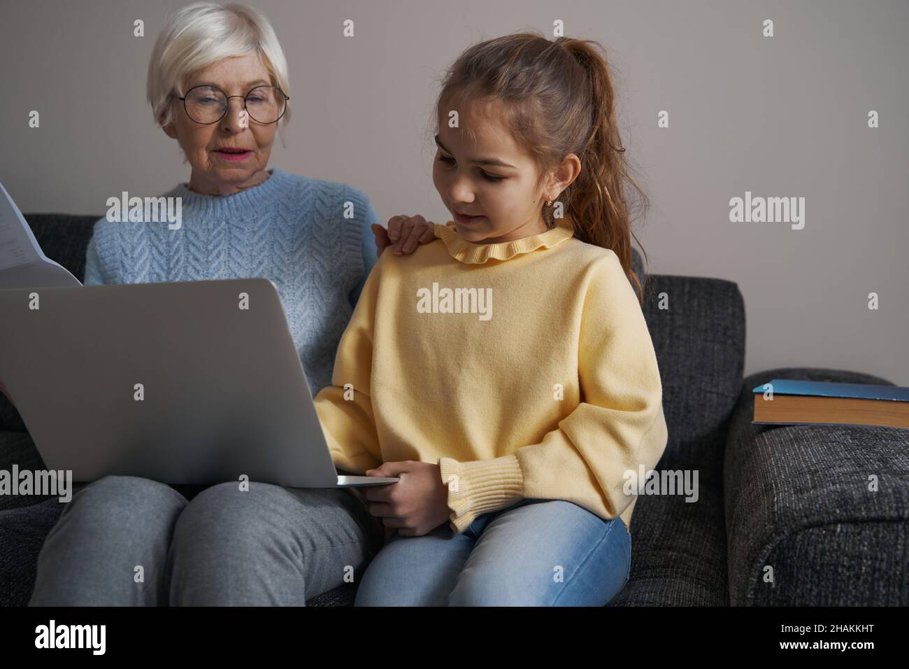 Intent child and grandma watching laptop screen at home Stock Photo - Alamy