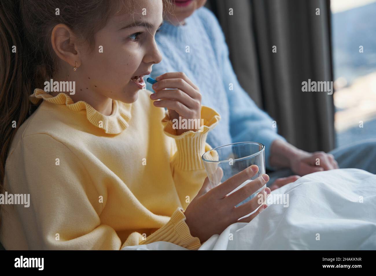Well-behaved little girl taking medication for her sickness Stock Photo ...