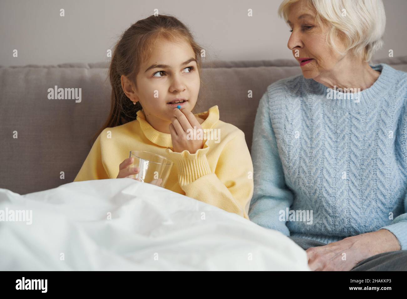 Sick child taking medication to feel better Stock Photo - Alamy