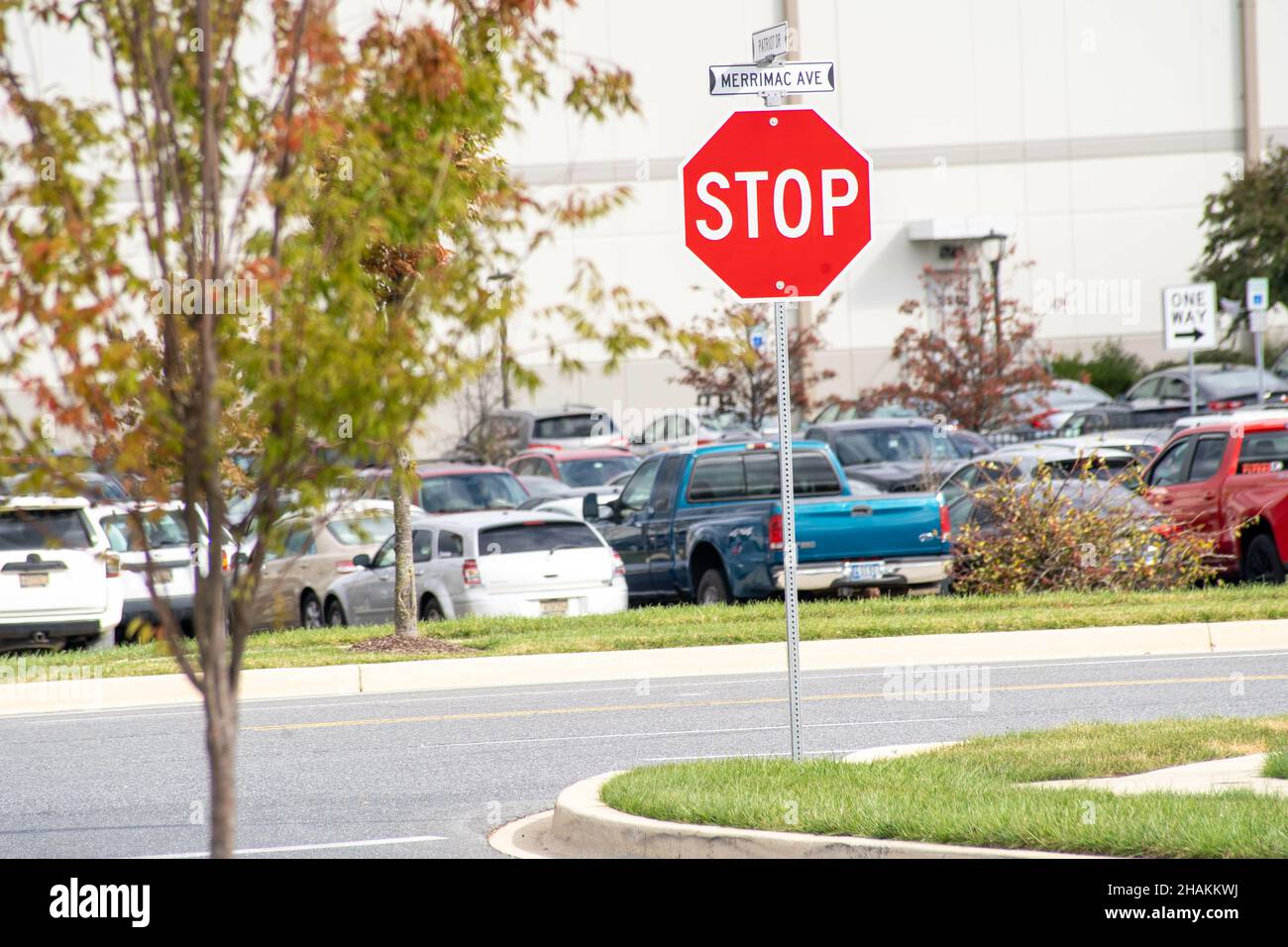 Red stop sign on a road near a parking lot Stock Photo - Alamy