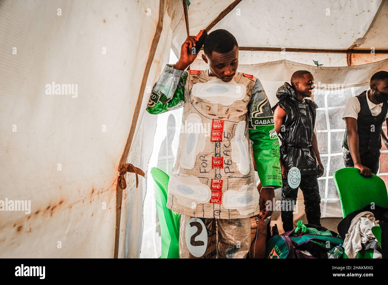 Young male models change into their modeling outfits during the Mr. and ...