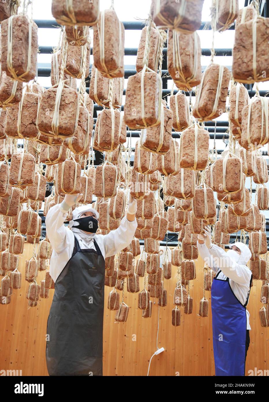 14th Dec, 2021. Drying bean paste to make soy sauce Employees inspect ...